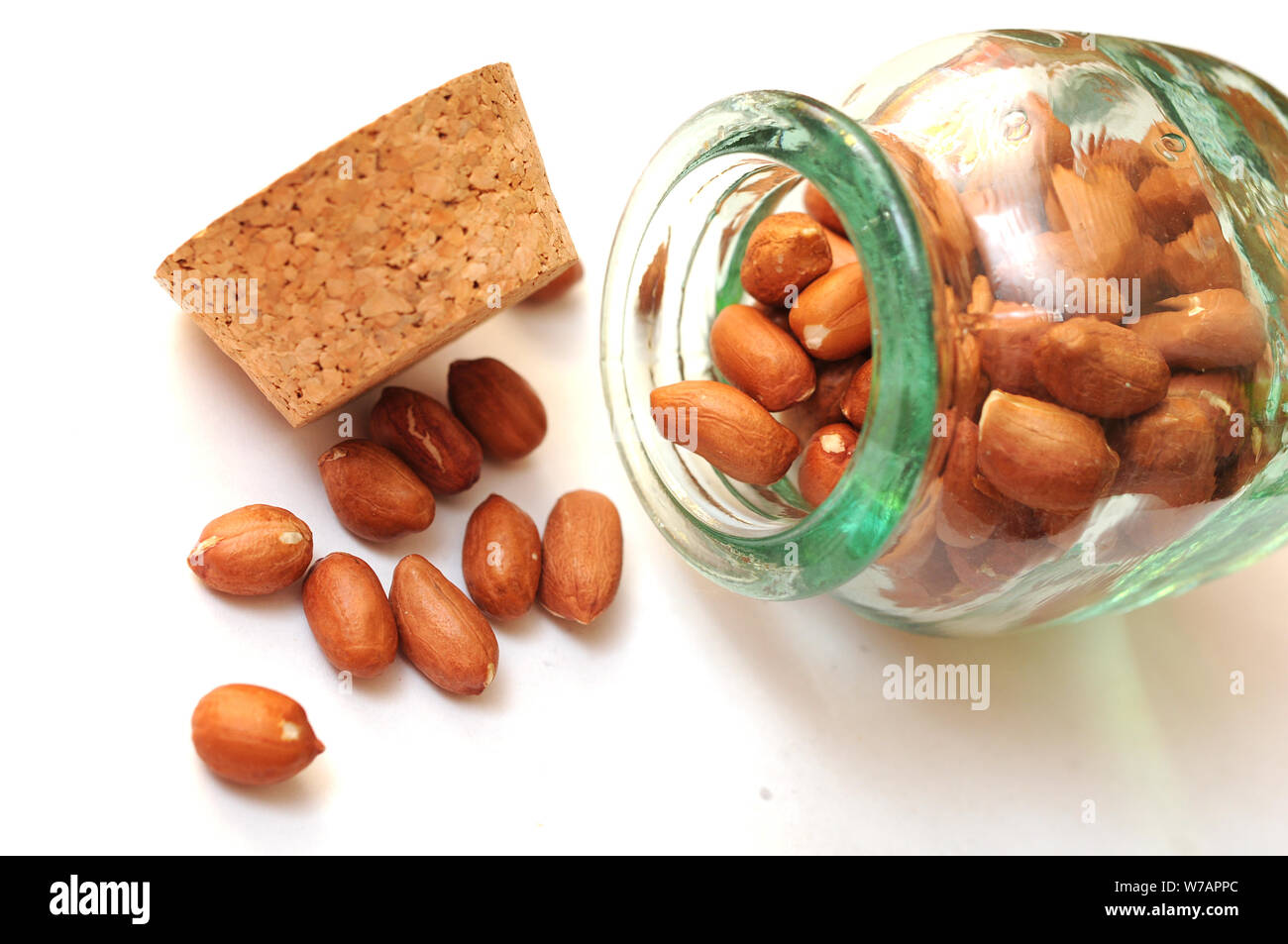 peanuts in glass jar on white background Stock Photo - Alamy