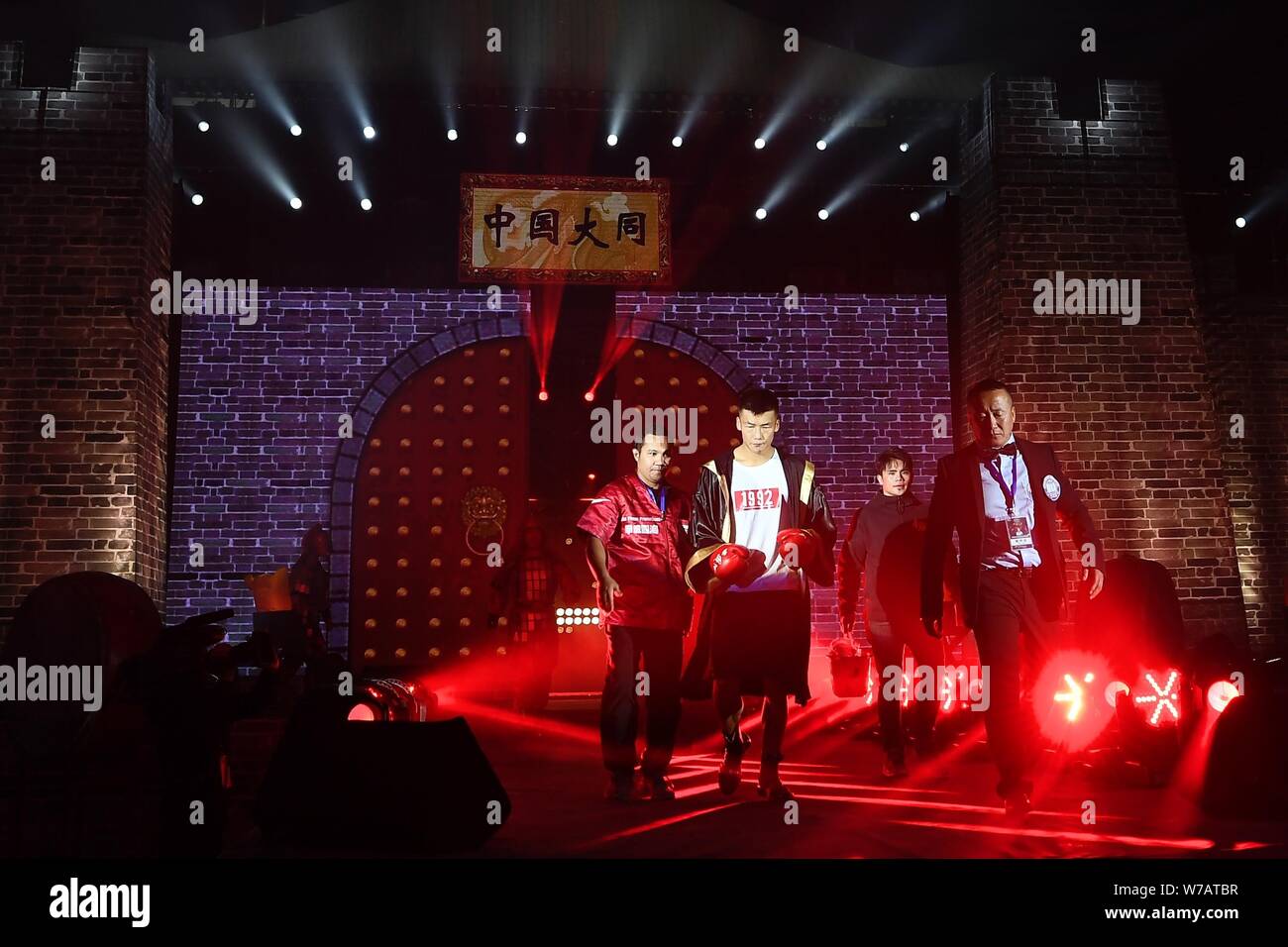 Chinese boxer Yang Xingxin, center, prepares to compete against ...
