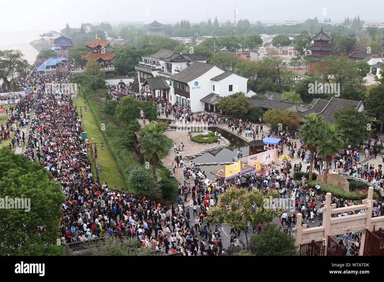 Visitors and local residents throng to watch the tidal bore of the ...