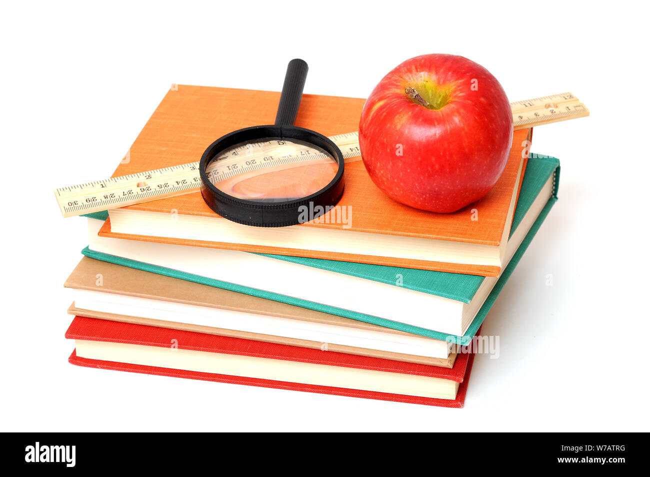 apple, magnifying, ruler and books on white Stock Photo - Alamy