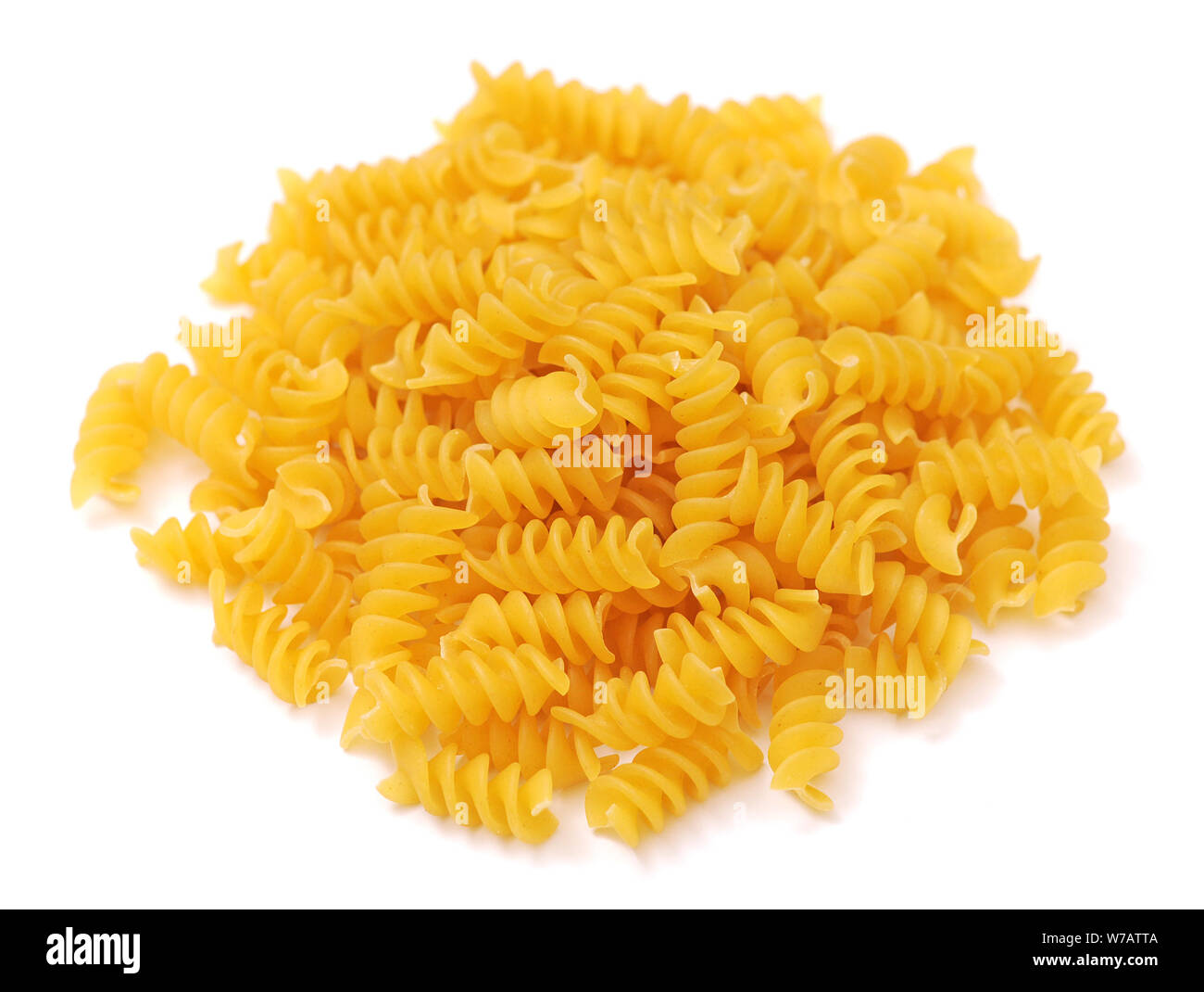 a pile of spiral pasta on white background Stock Photo - Alamy