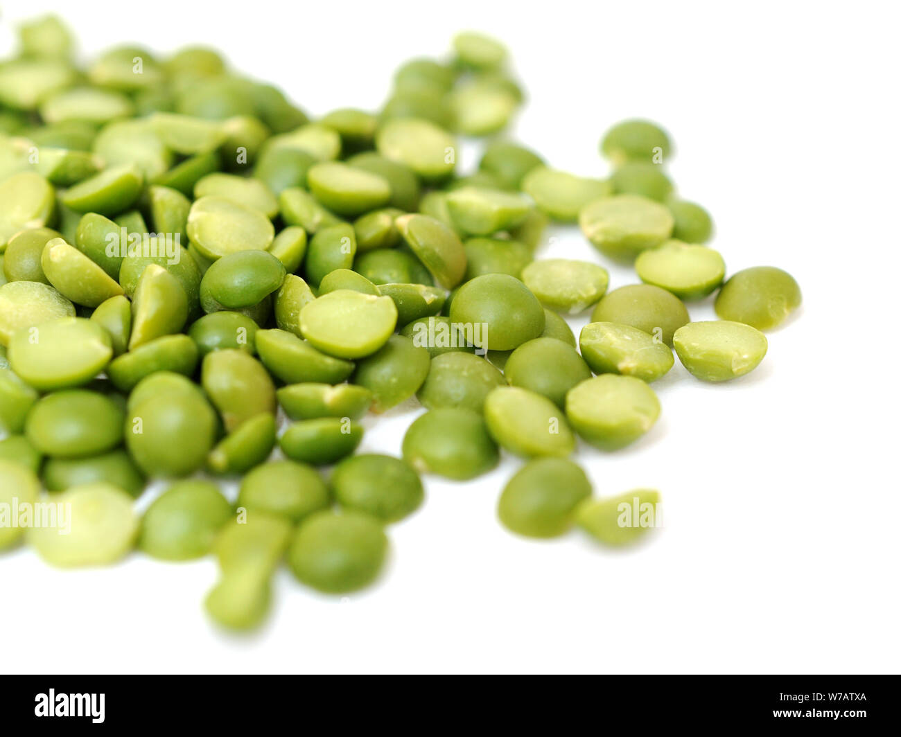 a pile of green split pea on white background Stock Photo - Alamy