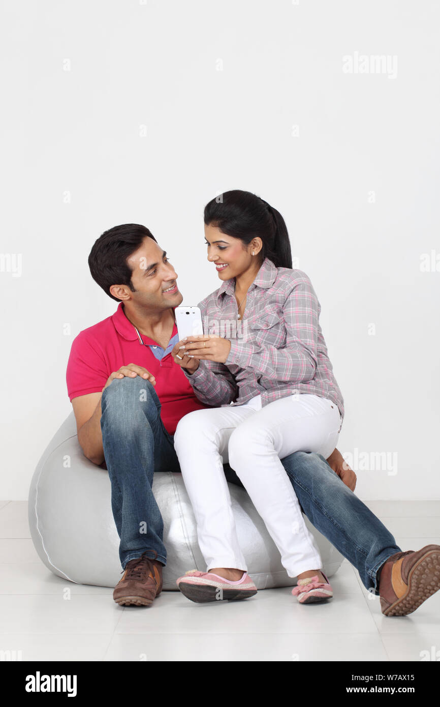 Young woman showing text message to her husband Stock Photo - Alamy