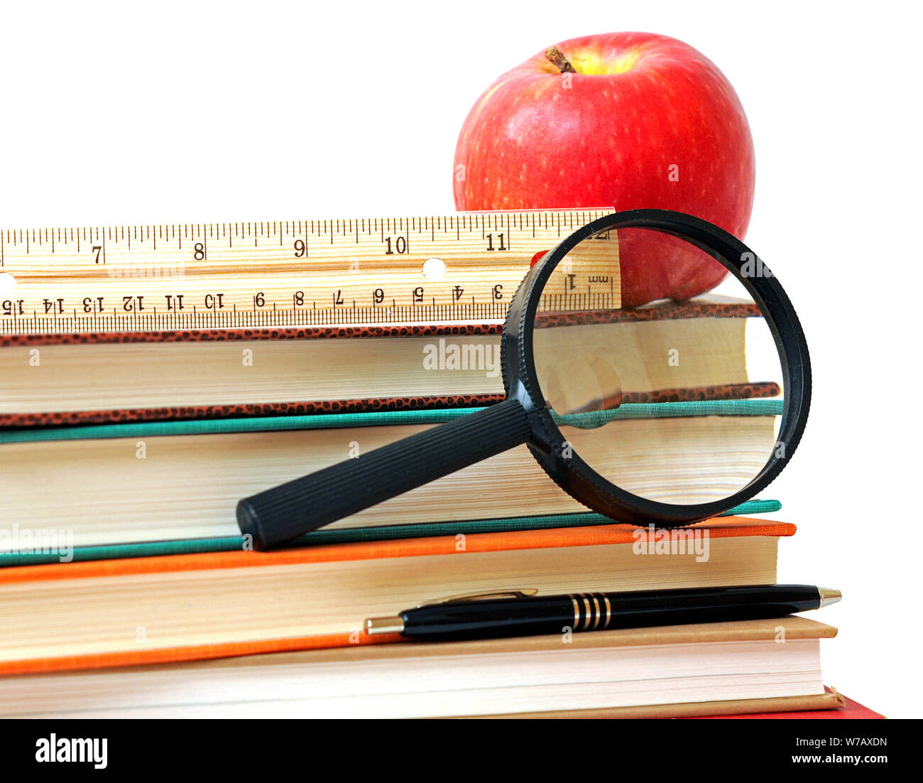 apple, magnifying and books on white Stock Photo - Alamy