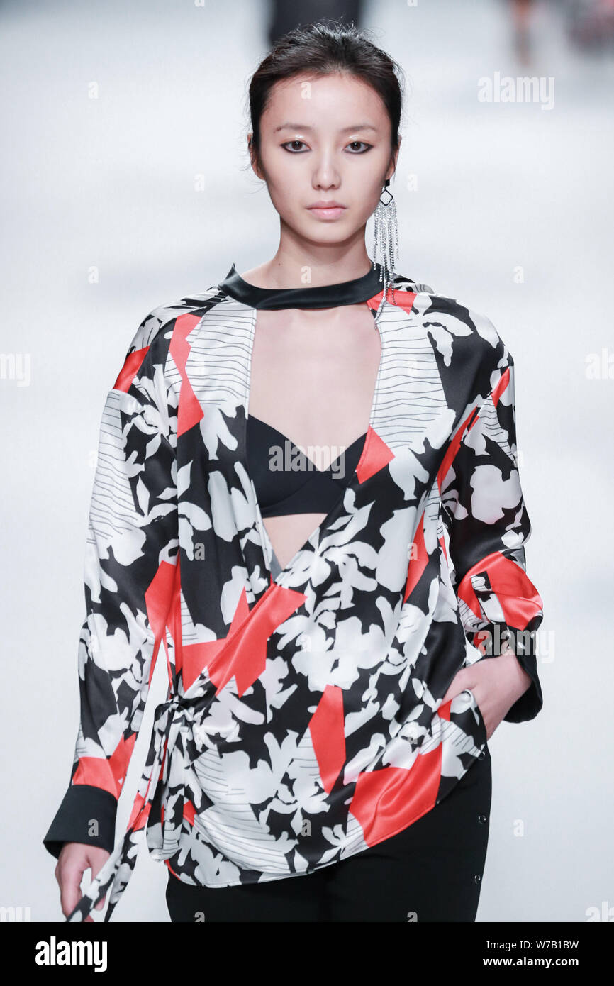 A model displays a new creation at the fashion show of Anirac during the Shanghai Fashion Week ...