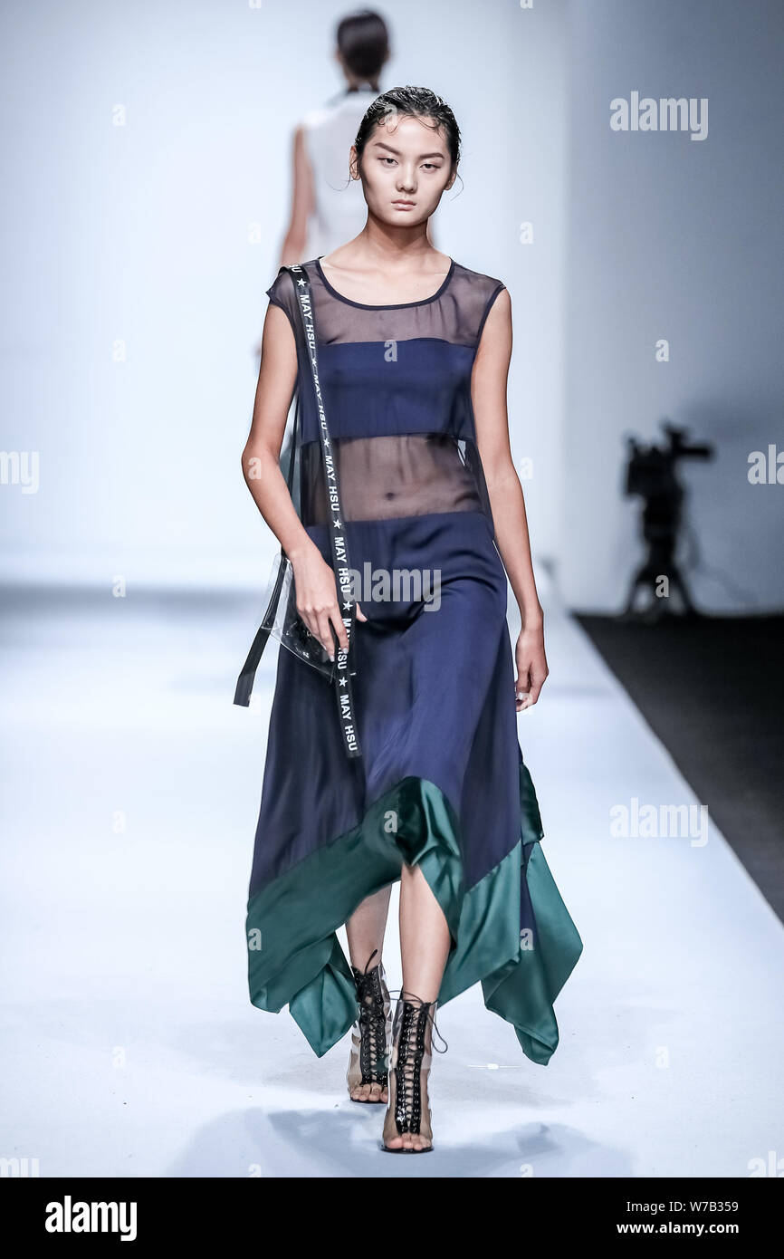 A model displays a new creation at the fashion show of May Hsu during the Shanghai Fashion Week ...