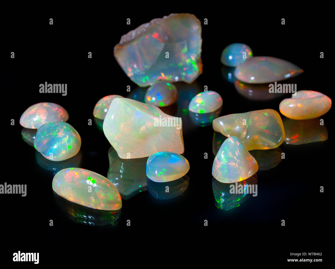 Composition of precious opal jewels. Cuts and rough material Stock ...