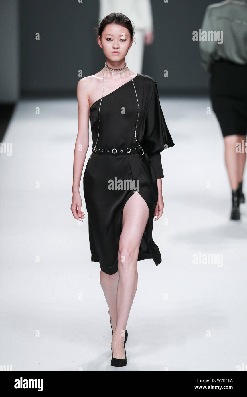 A model displays a new creation at the fashion show of Anirac during the Shanghai Fashion Week ...