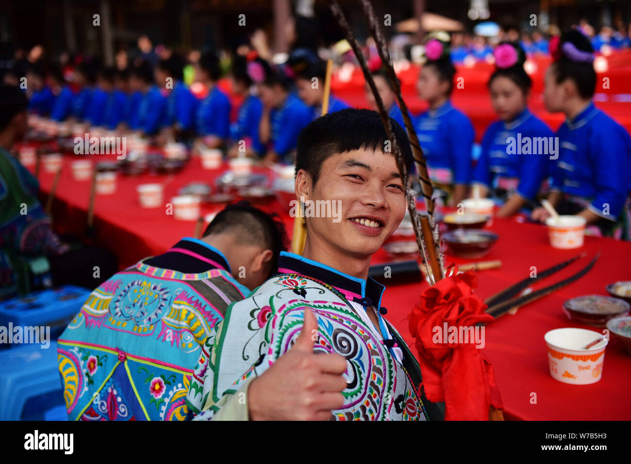 A Chinese young man of Miao ethnic minority dressed in traditional ...