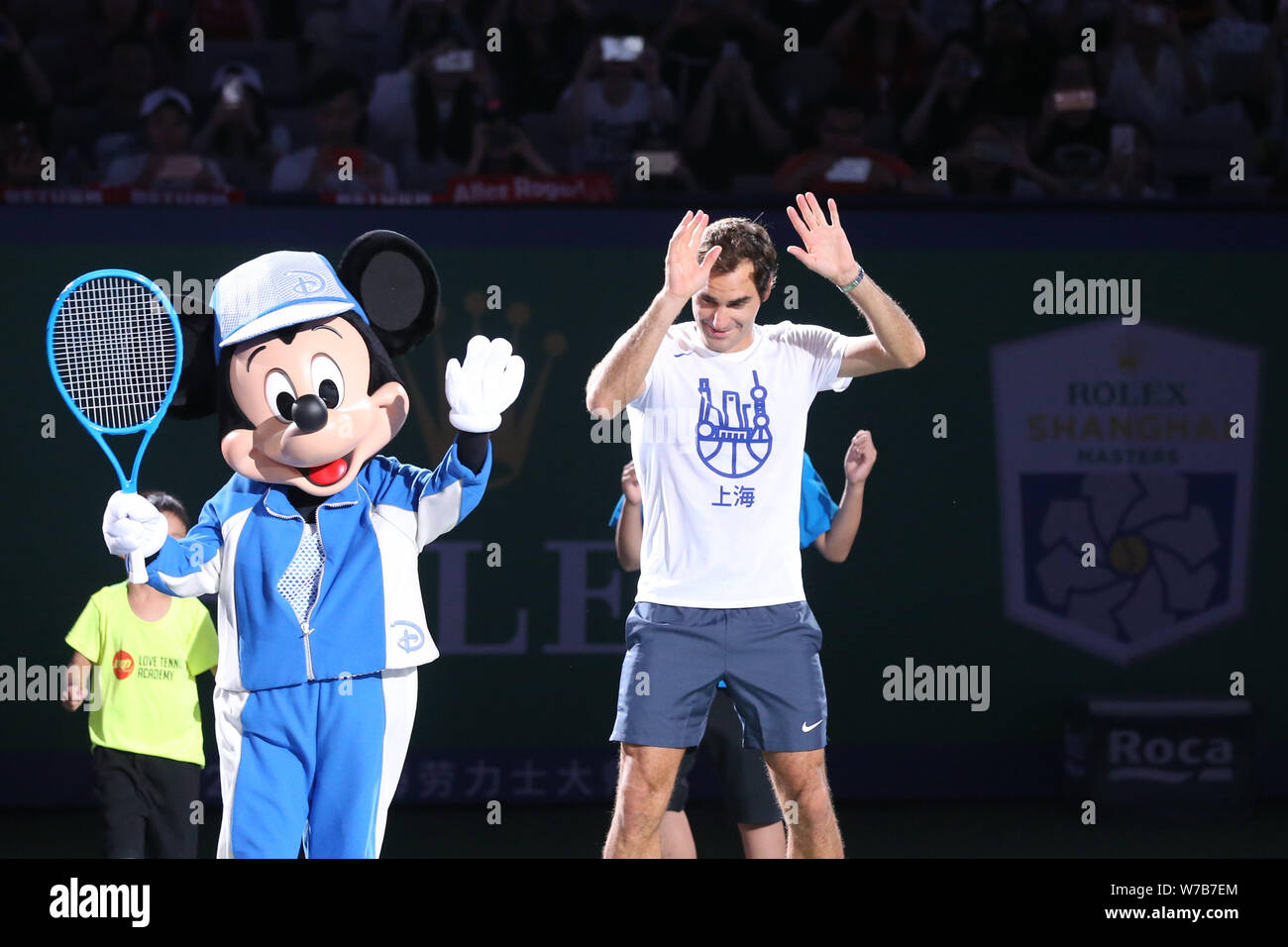 Swiss tennis player Roger Federer enjoys a dance-off with Mickey Mouse ...