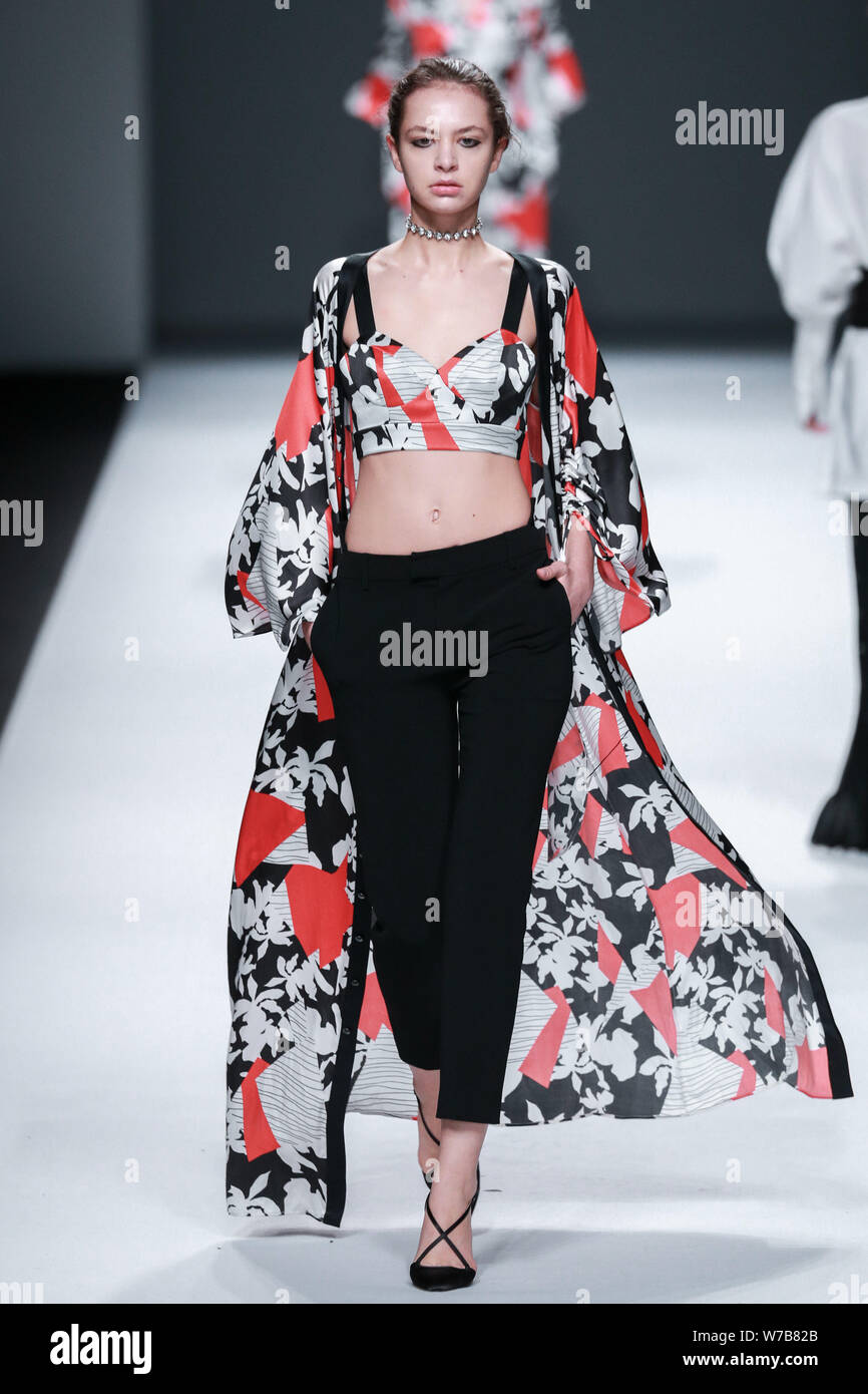 A model displays a new creation at the fashion show of Anirac during the Shanghai Fashion Week ...