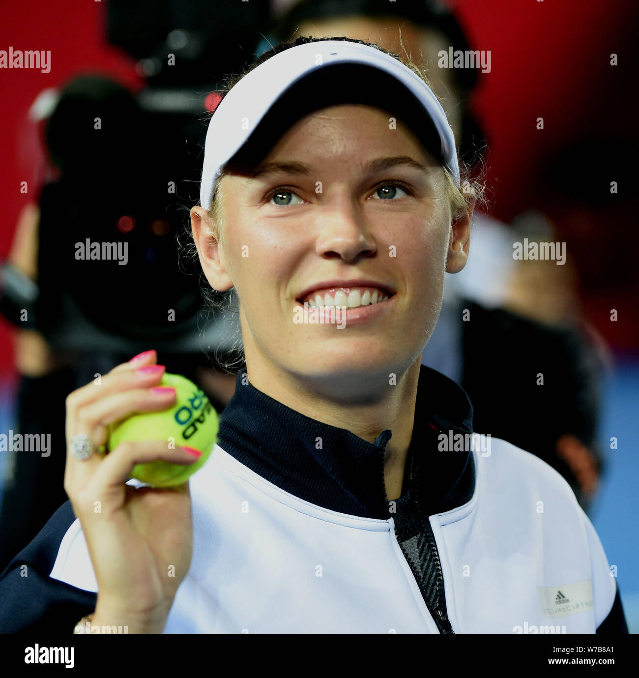 Danish tennis player Caroline Wozniacki throws tennis balls with her ...