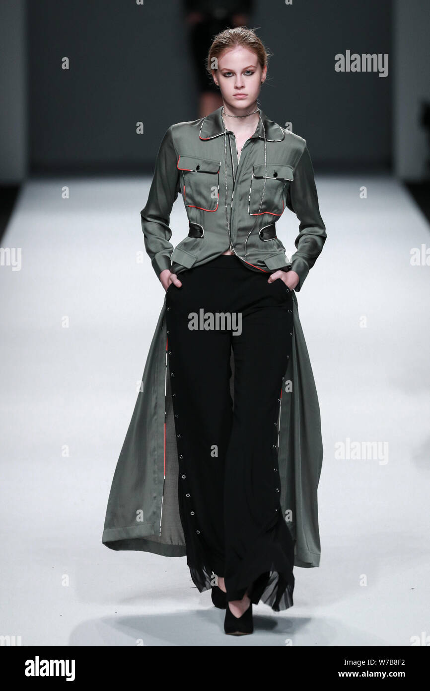 A model displays a new creation at the fashion show of Anirac during the Shanghai Fashion Week ...