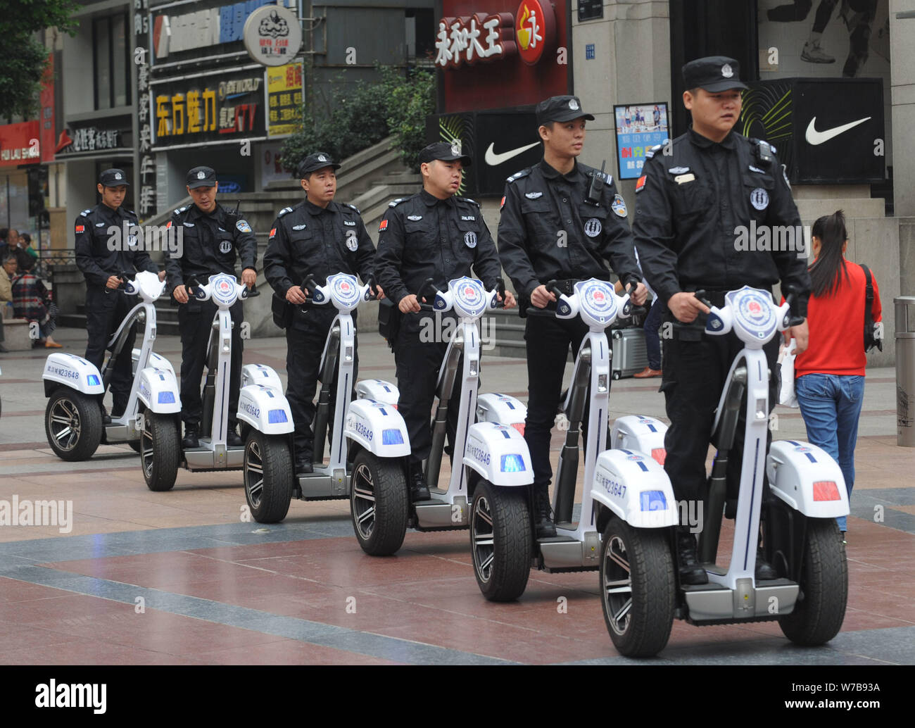Chinese urban enforcement officers, also known as chengguan, ride self ...