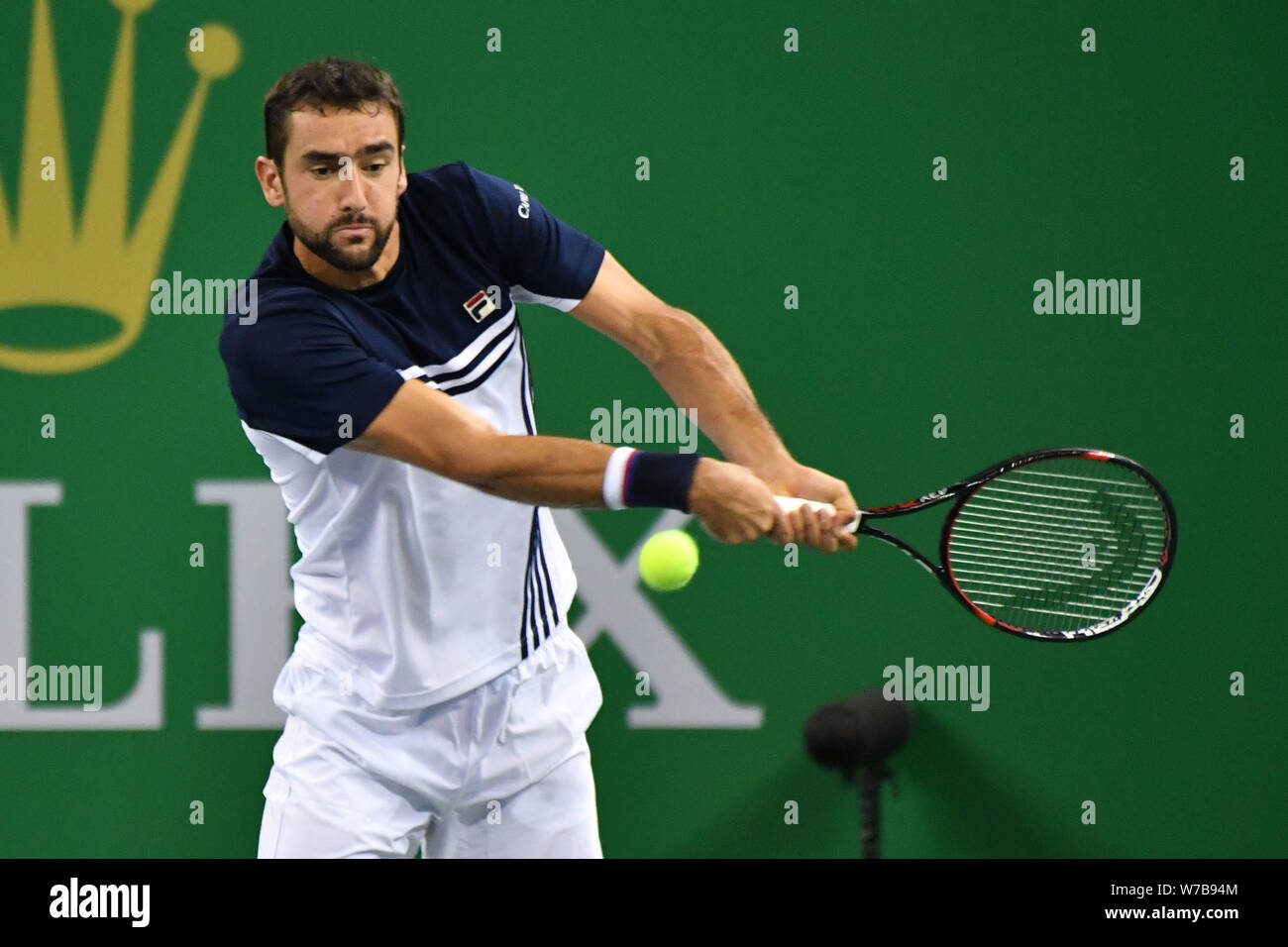 Marin Cilic of Croatia returns a shot to Steve Johnson of the United ...