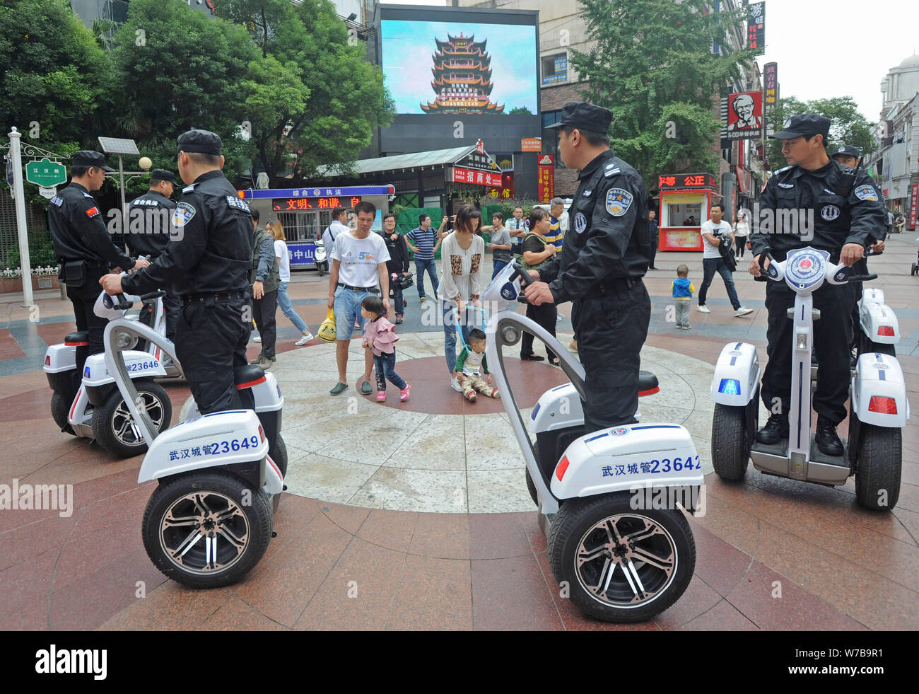 Chinese urban enforcement officers, also known as chengguan, ride self ...