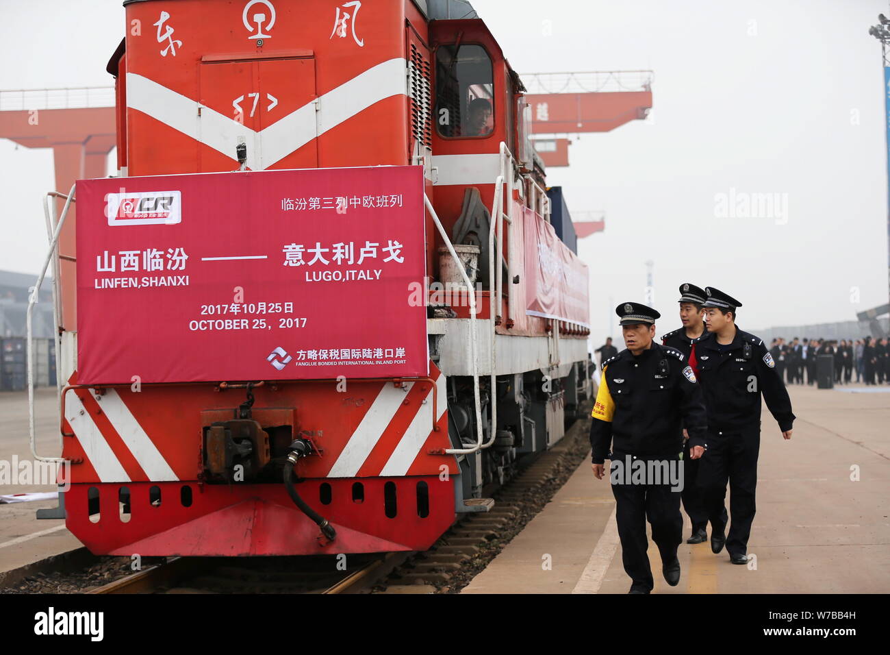 Chinese police officers check a freight train of China Railway Express ...