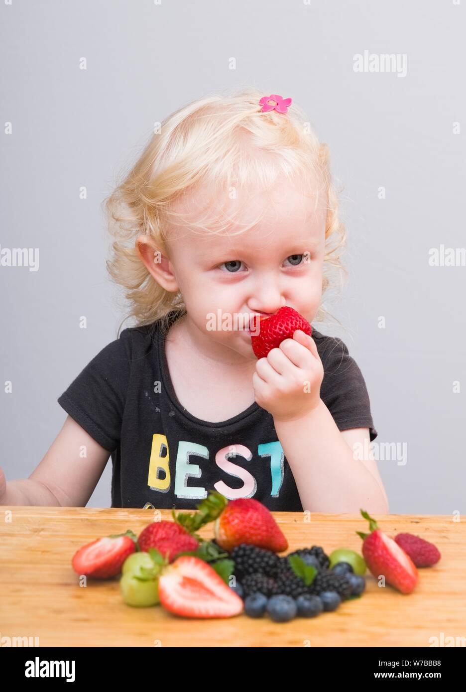 Baby girl eating blueberries hi-res stock photography and images - Alamy