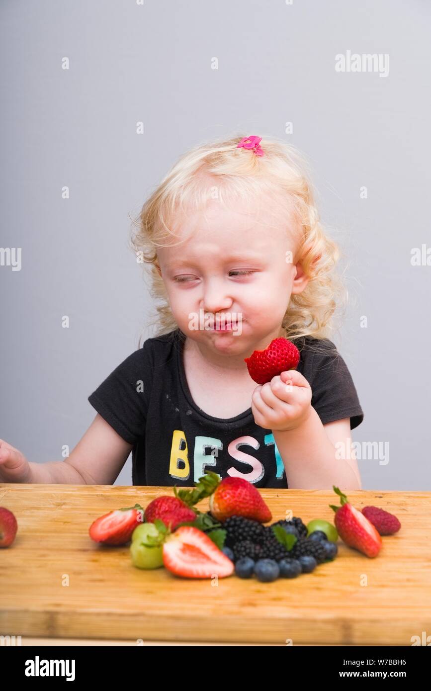 Baby girl eating blueberries hi-res stock photography and images - Alamy