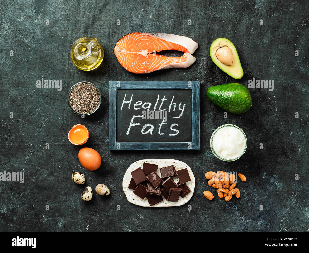 Healthy fats sources concept. Different food ingredients and chalkboard ...