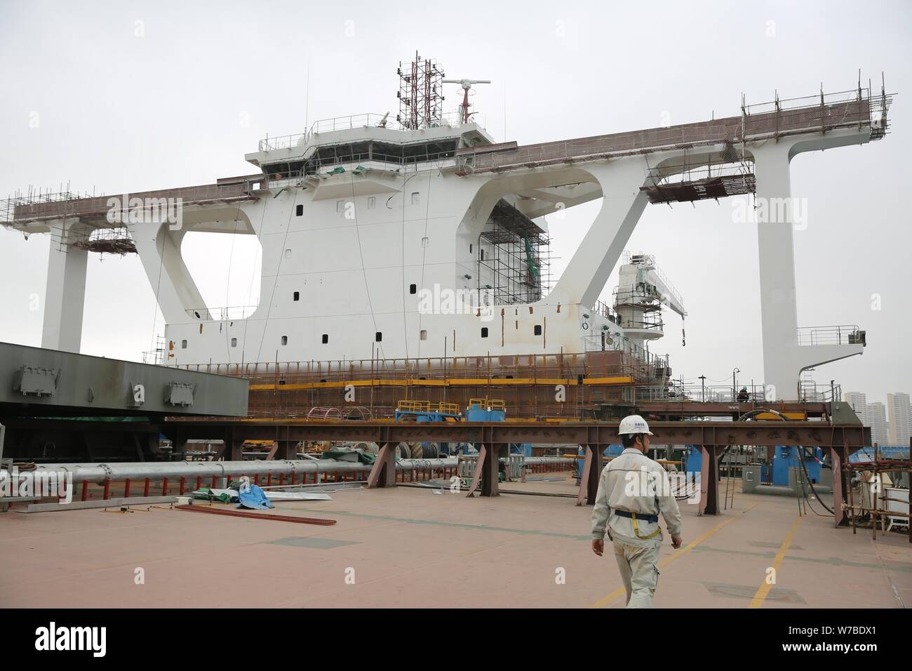 A Chinese worker walks past the world's largest bulk carrier ''Ore ...