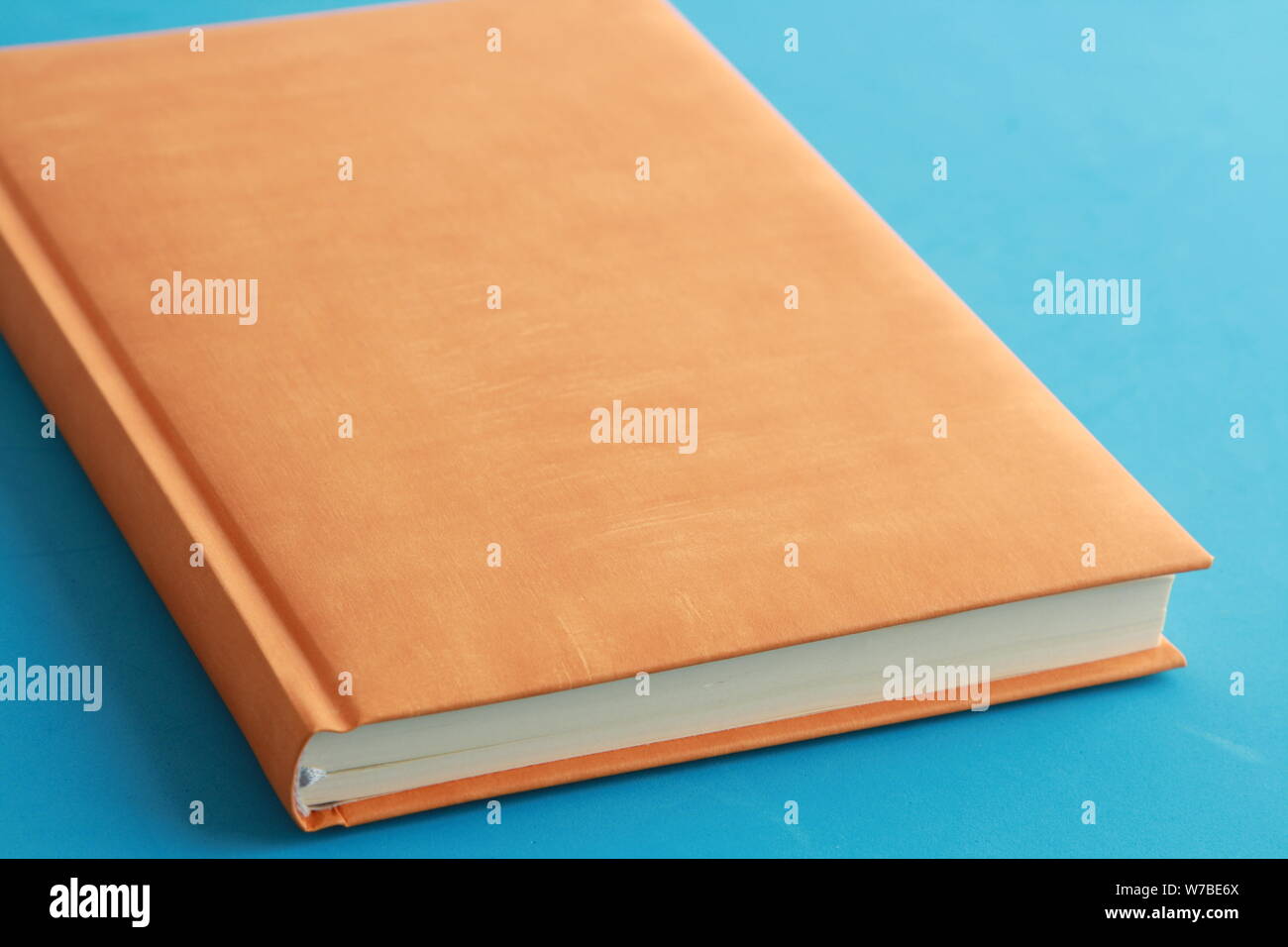 book with orange cover on colorful background Stock Photo - Alamy