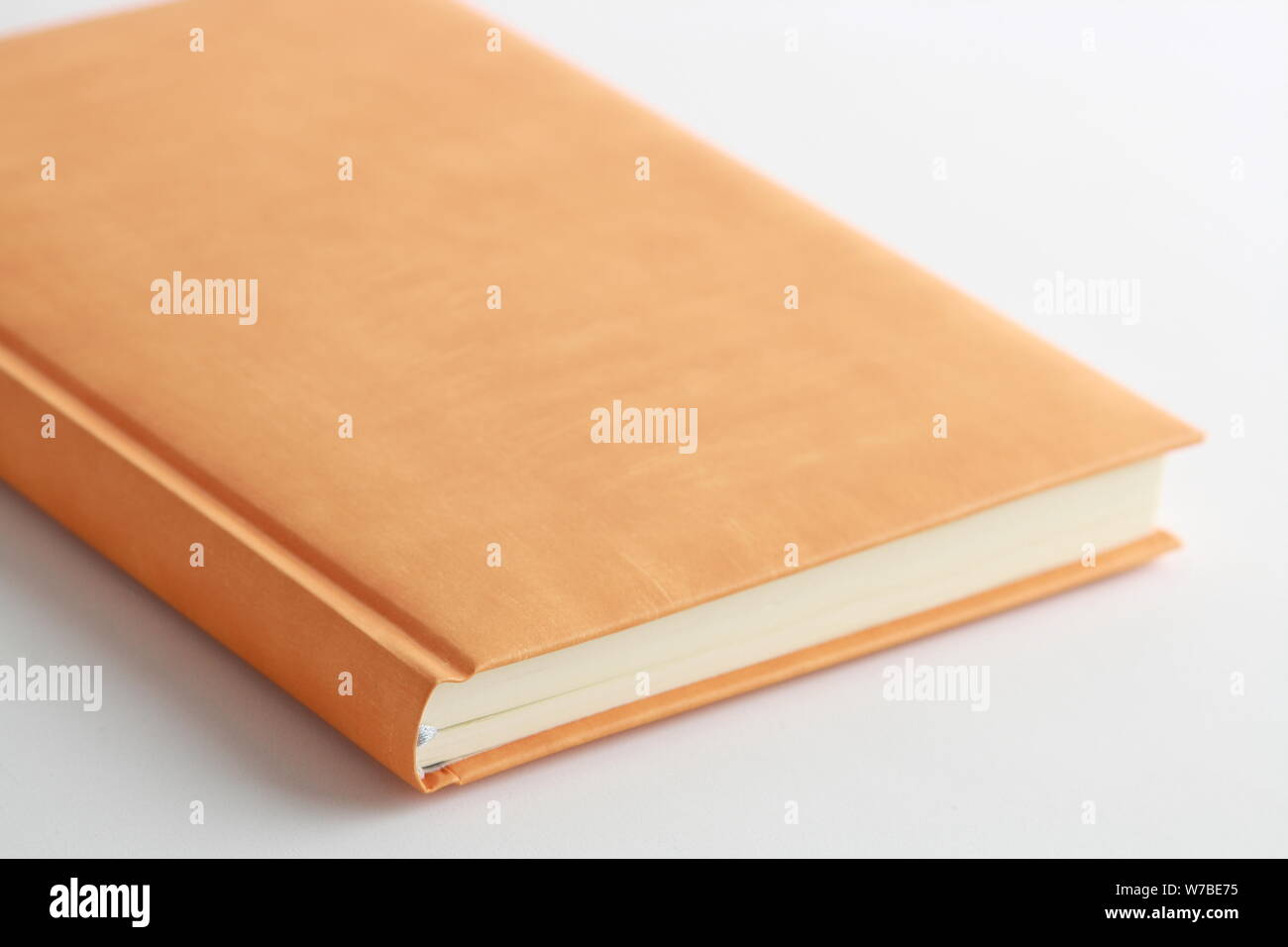 book with orange cover on colorful background Stock Photo - Alamy