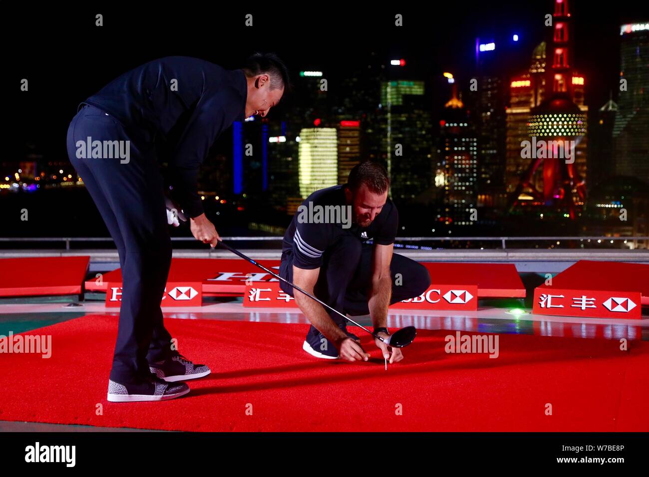 Dustin Johnson of the United States, right, and Li Haotong of China ...