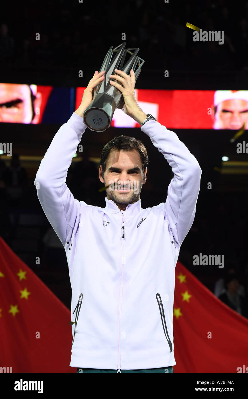 Roger Federer of Switzerland holds up his trophy after defeating Rafael ...