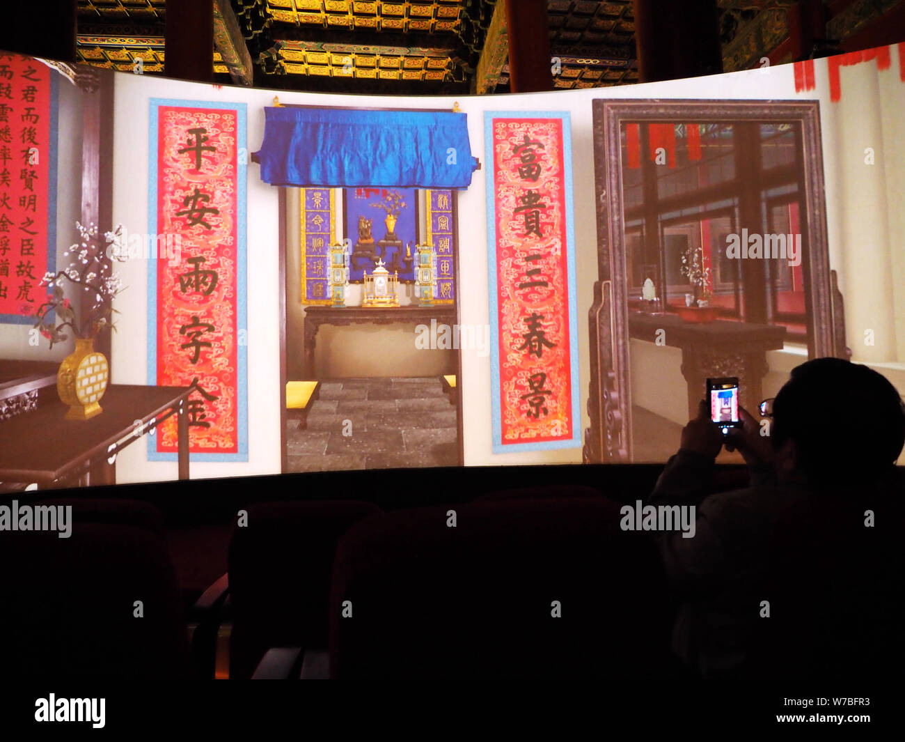 A visitor views the Palace Museum in a video during the exhibiton ...