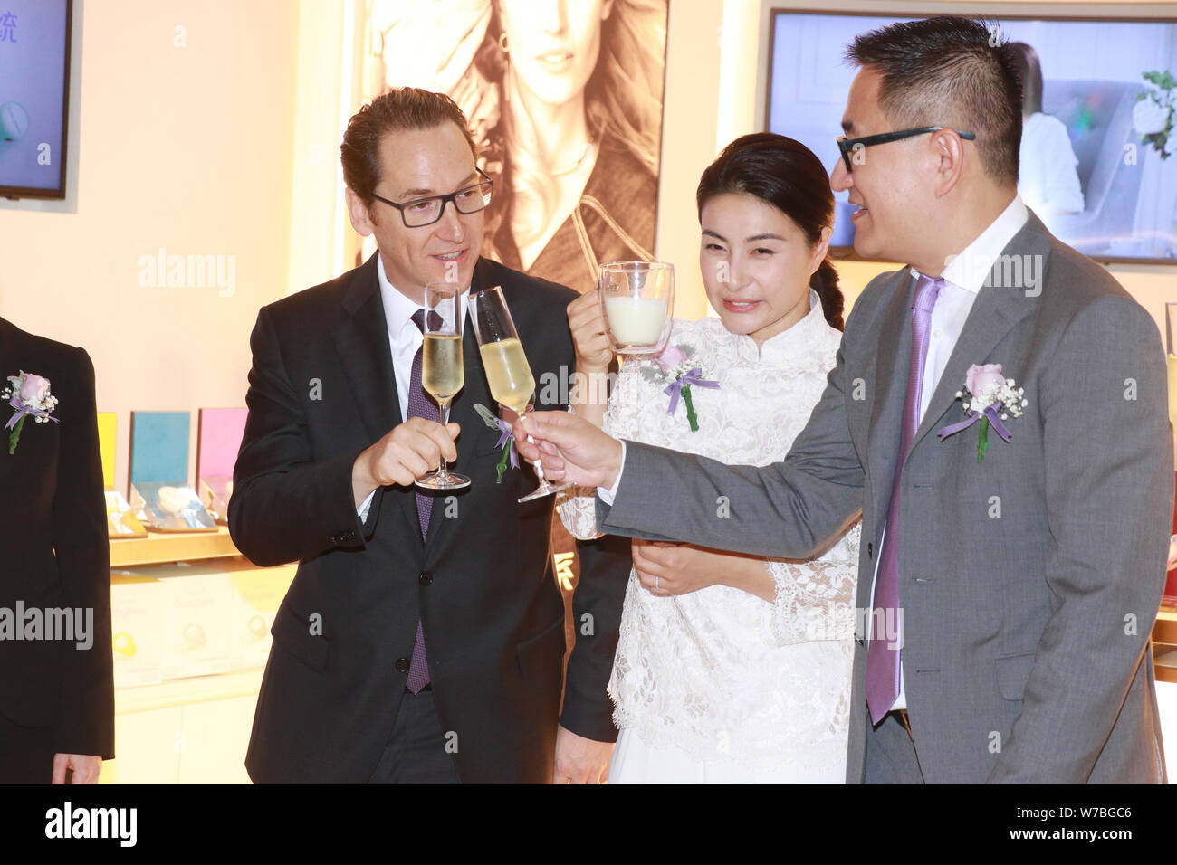 Chinese Olympic diving champion Guo Jingjing, center, who is married to ...