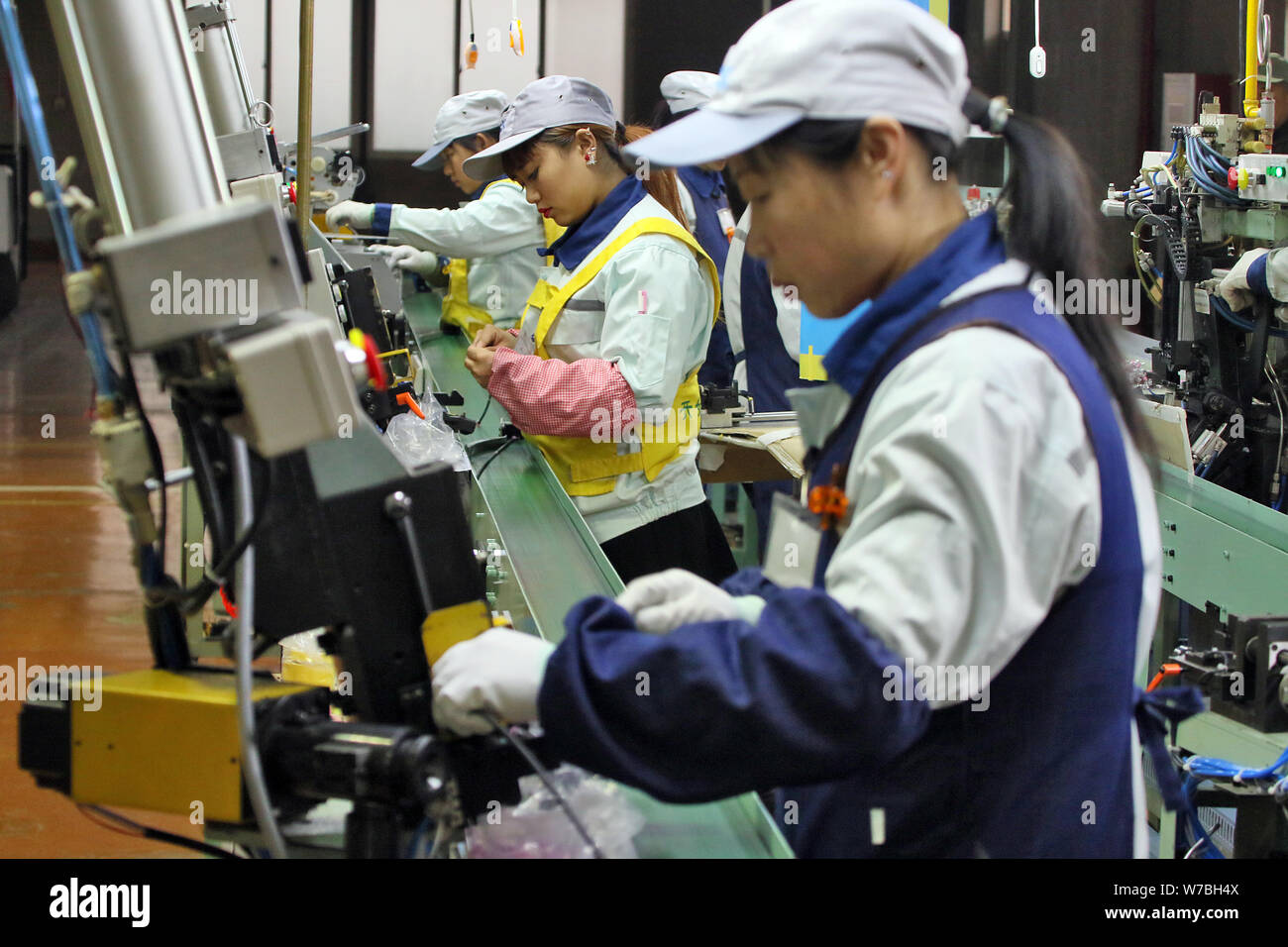 --FILE--Female Chinese workers produce electric products on the ...