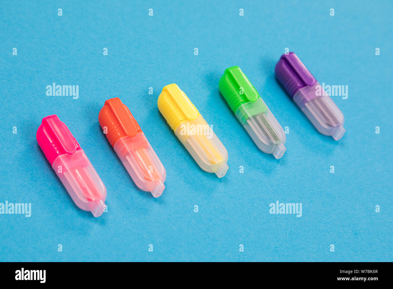 Five small multicolored highlighters on azure background isolated Stock ...