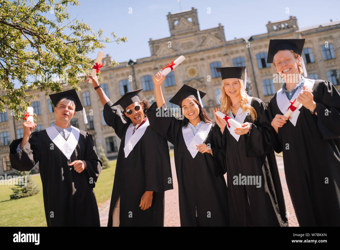Young people glad finally graduating the university Stock Photo - Alamy