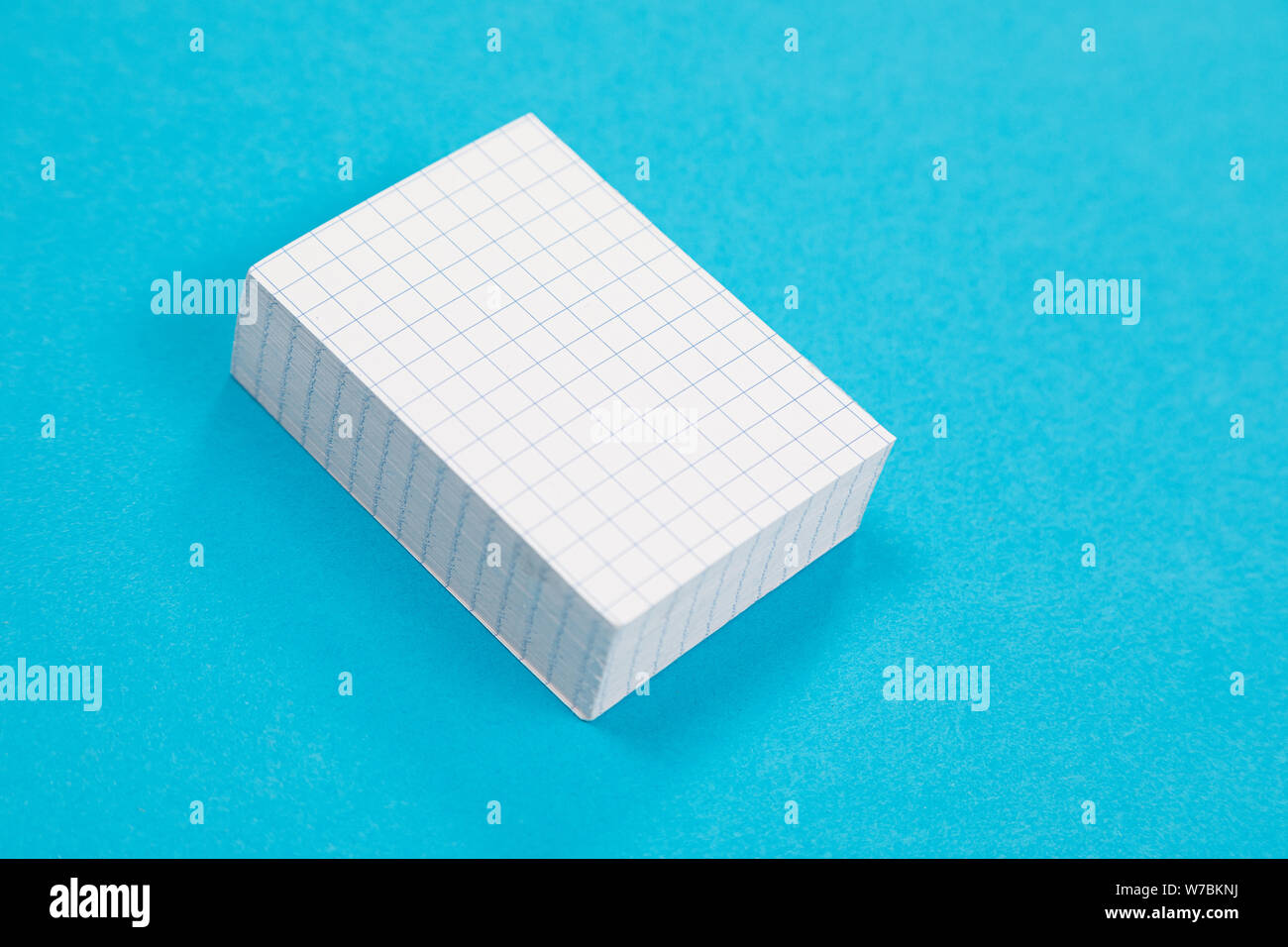 A pile of white scratch paper is lying on azure surface isolated Stock ...