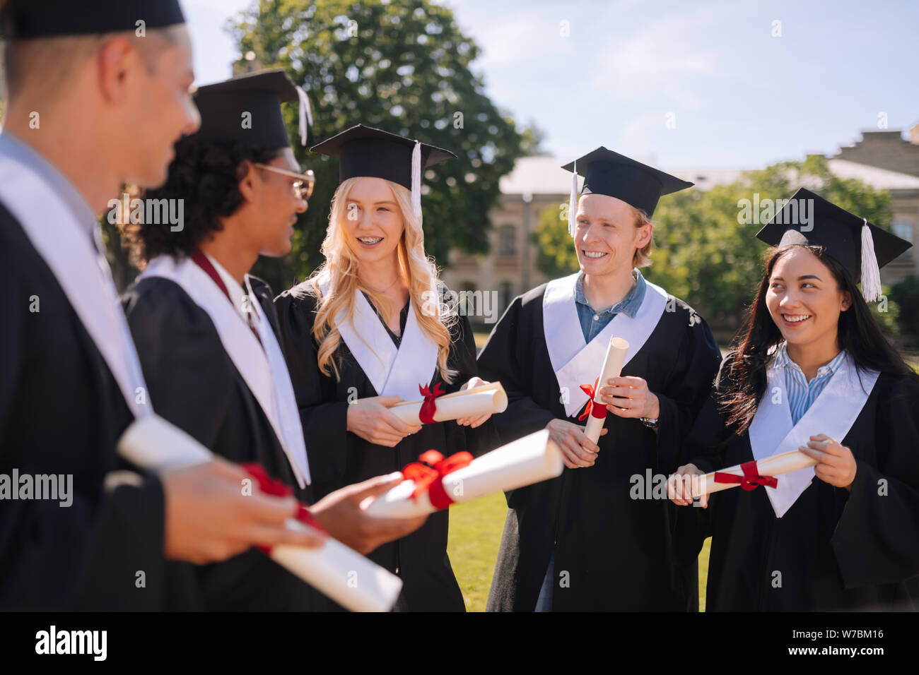 Happy graduates talking about their future plans Stock Photo - Alamy