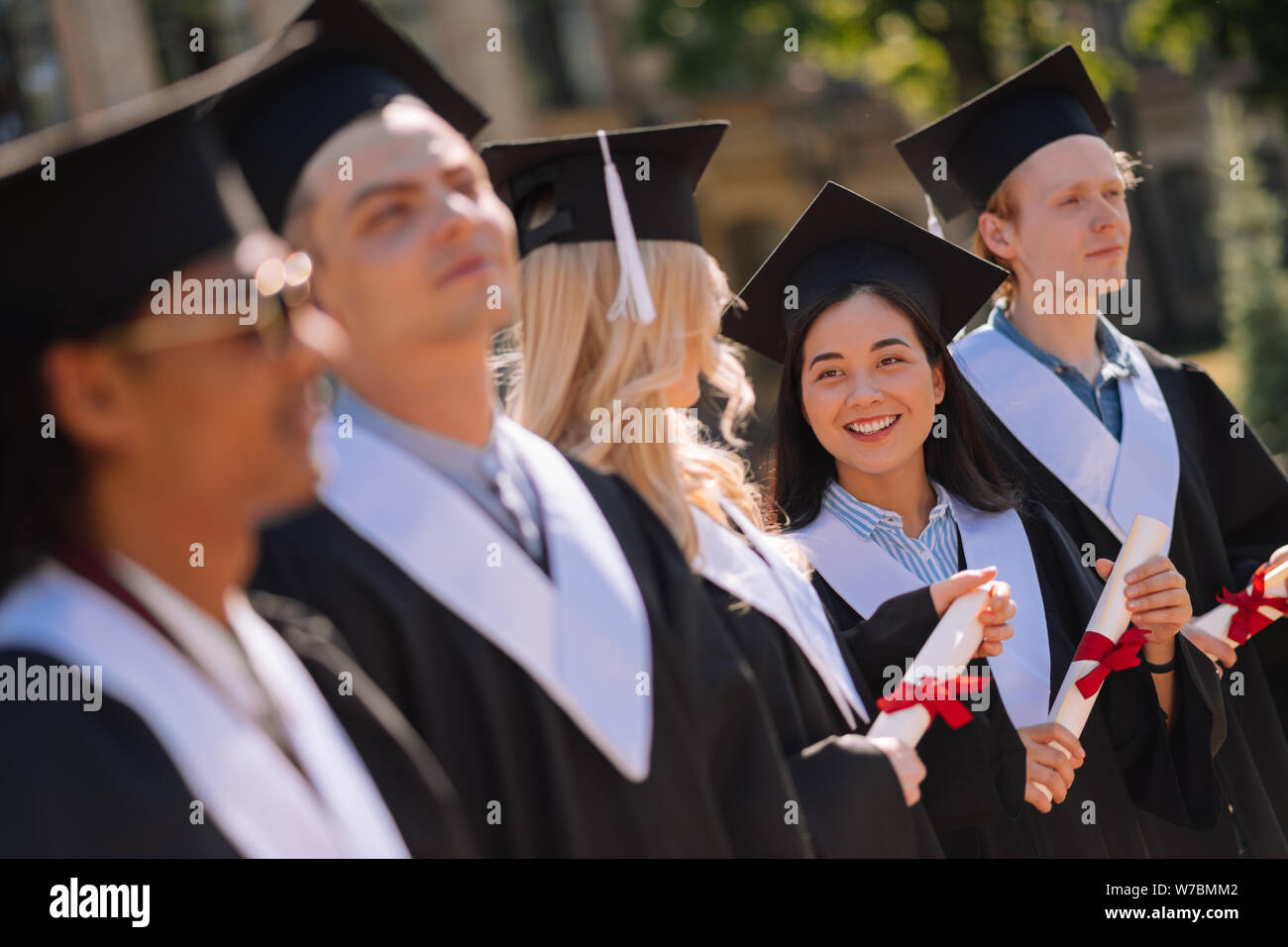 Two friends talking during their graduation ceremony Stock Photo - Alamy