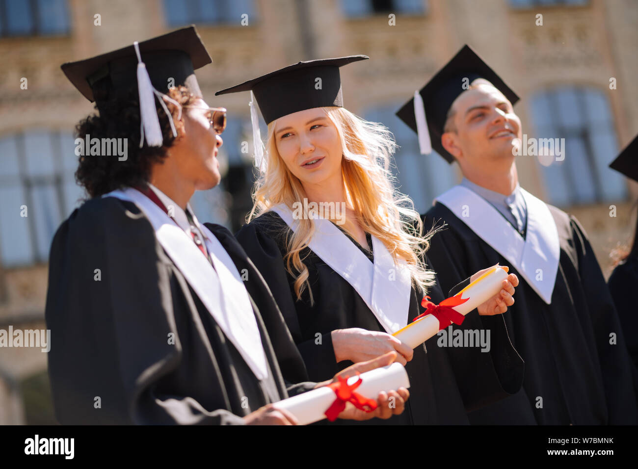 Girl and boy talking during their graduation Stock Photo - Alamy