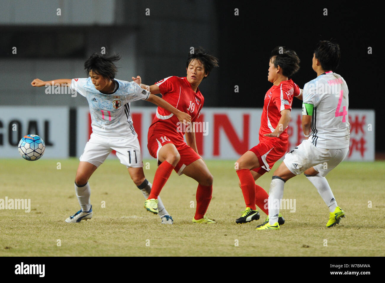 Saori Takarada, left, of Japan kicks the ball to make a pass against Ri ...