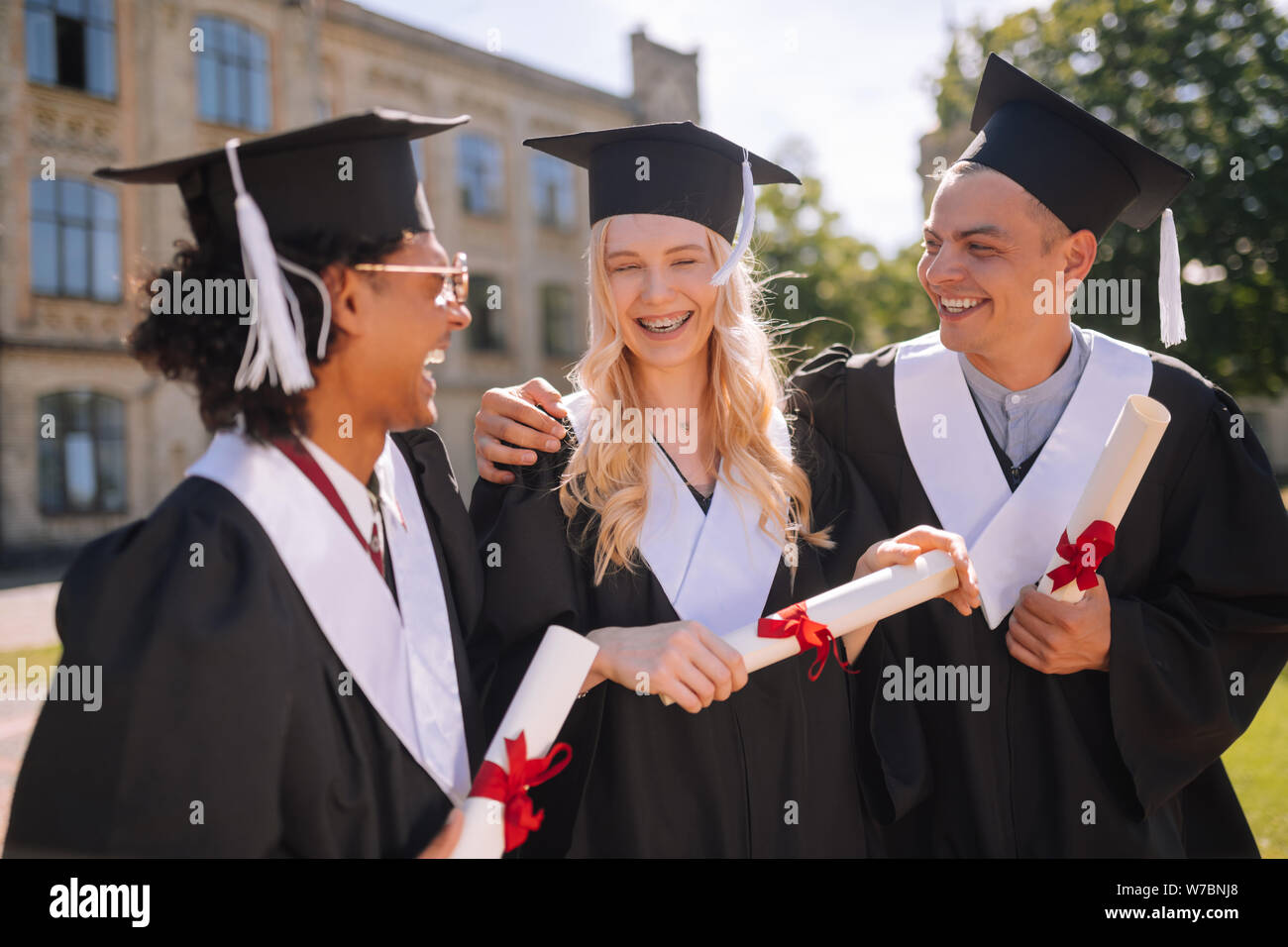 Three students being happy to graduate from the university Stock Photo ...