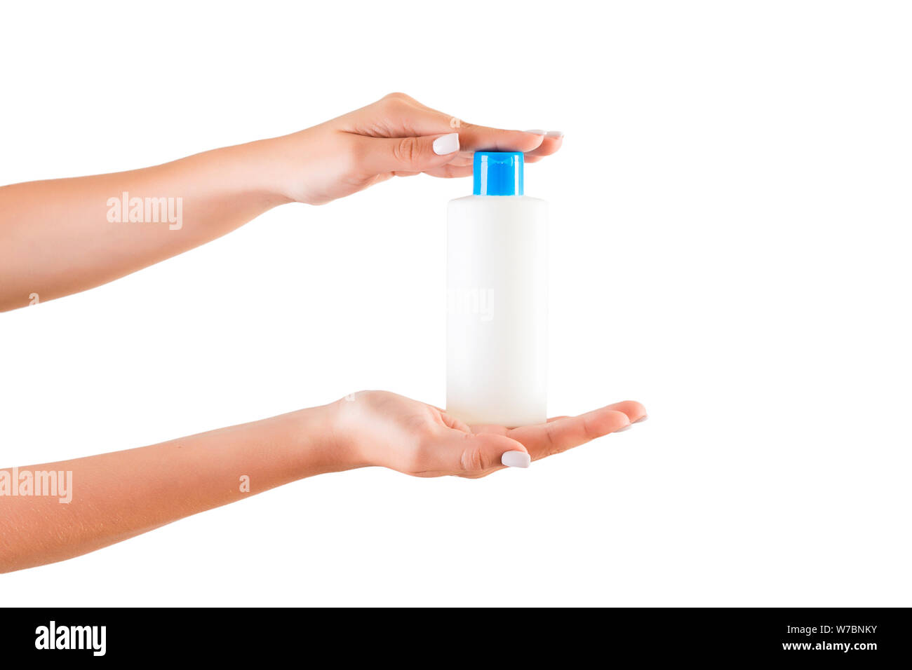 Female hand holding cream bottle of lotion isolated. Girl give cosmetic ...