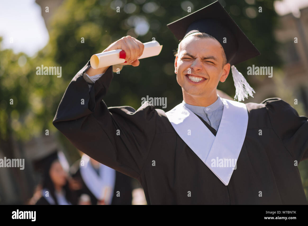 Excited graduate being happy to move on in his life Stock Photo - Alamy