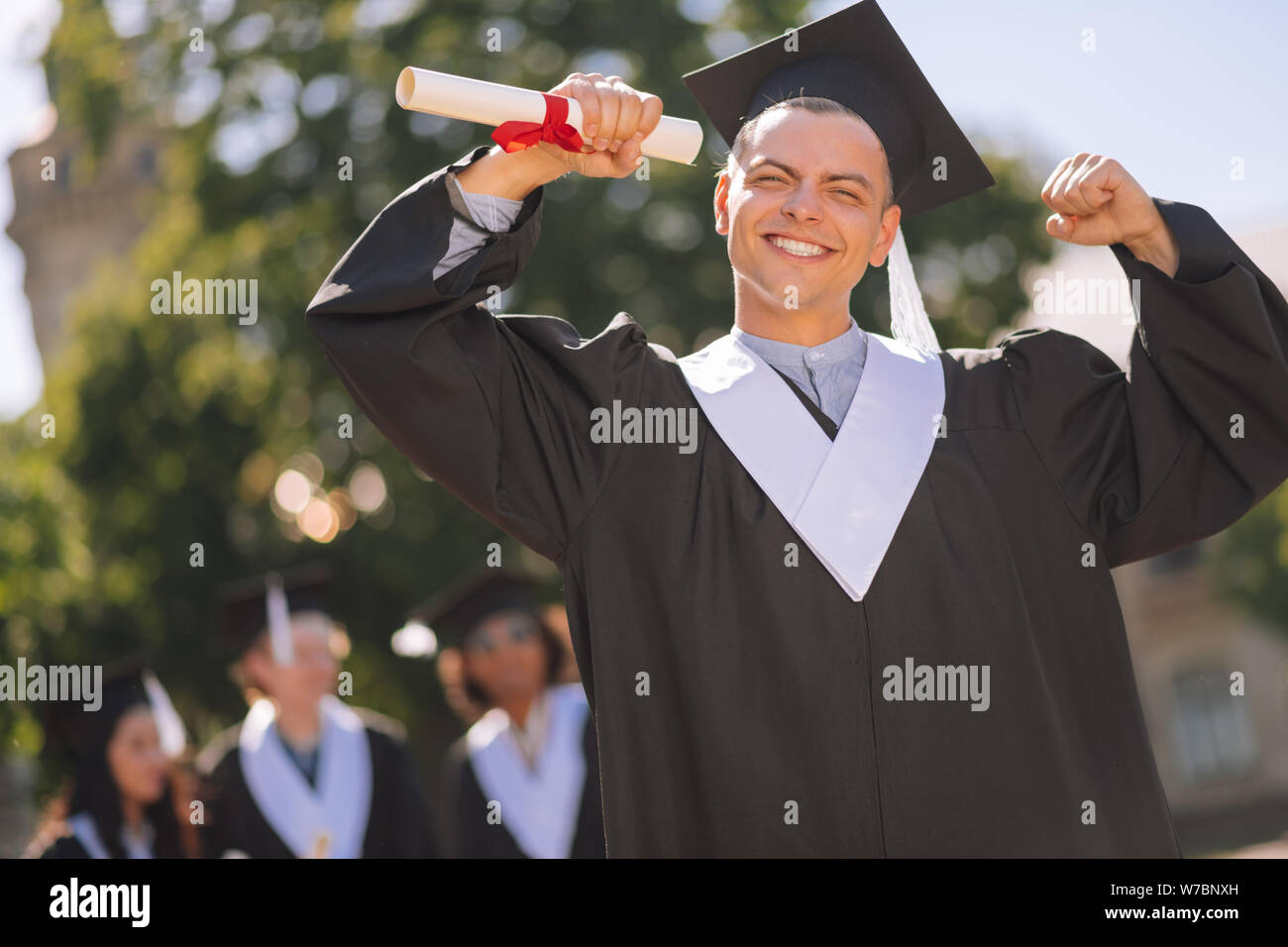 Cheerful boy being happy to graduate from the university Stock Photo ...