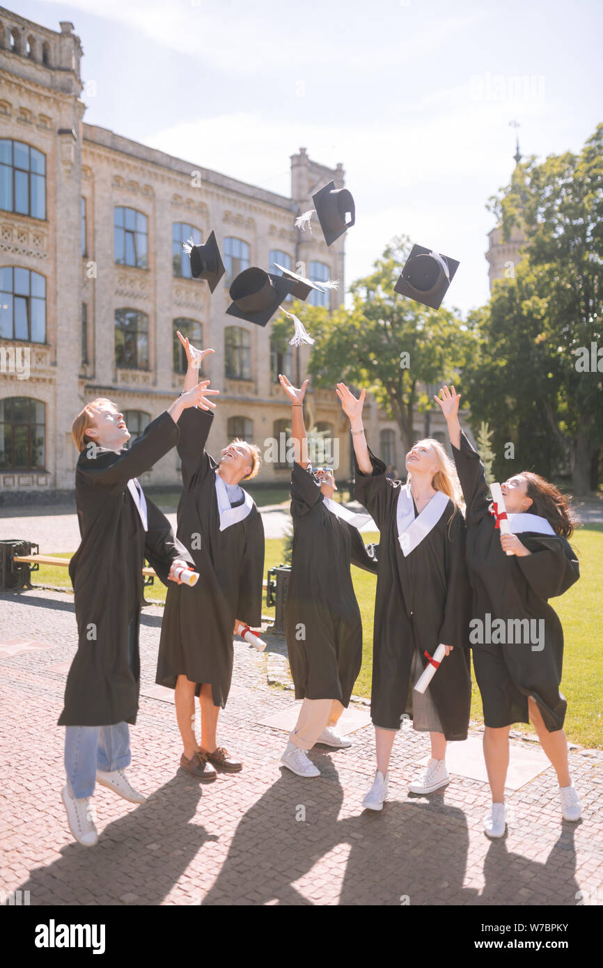 Graduation cap throwing hands hi-res stock photography and images - Alamy