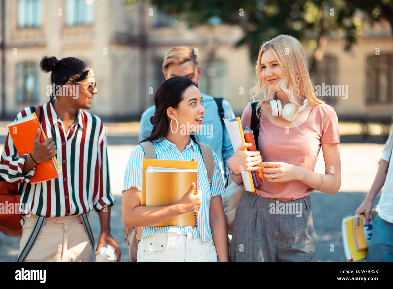 Groupmates talking and joking on their way home Stock Photo - Alamy
