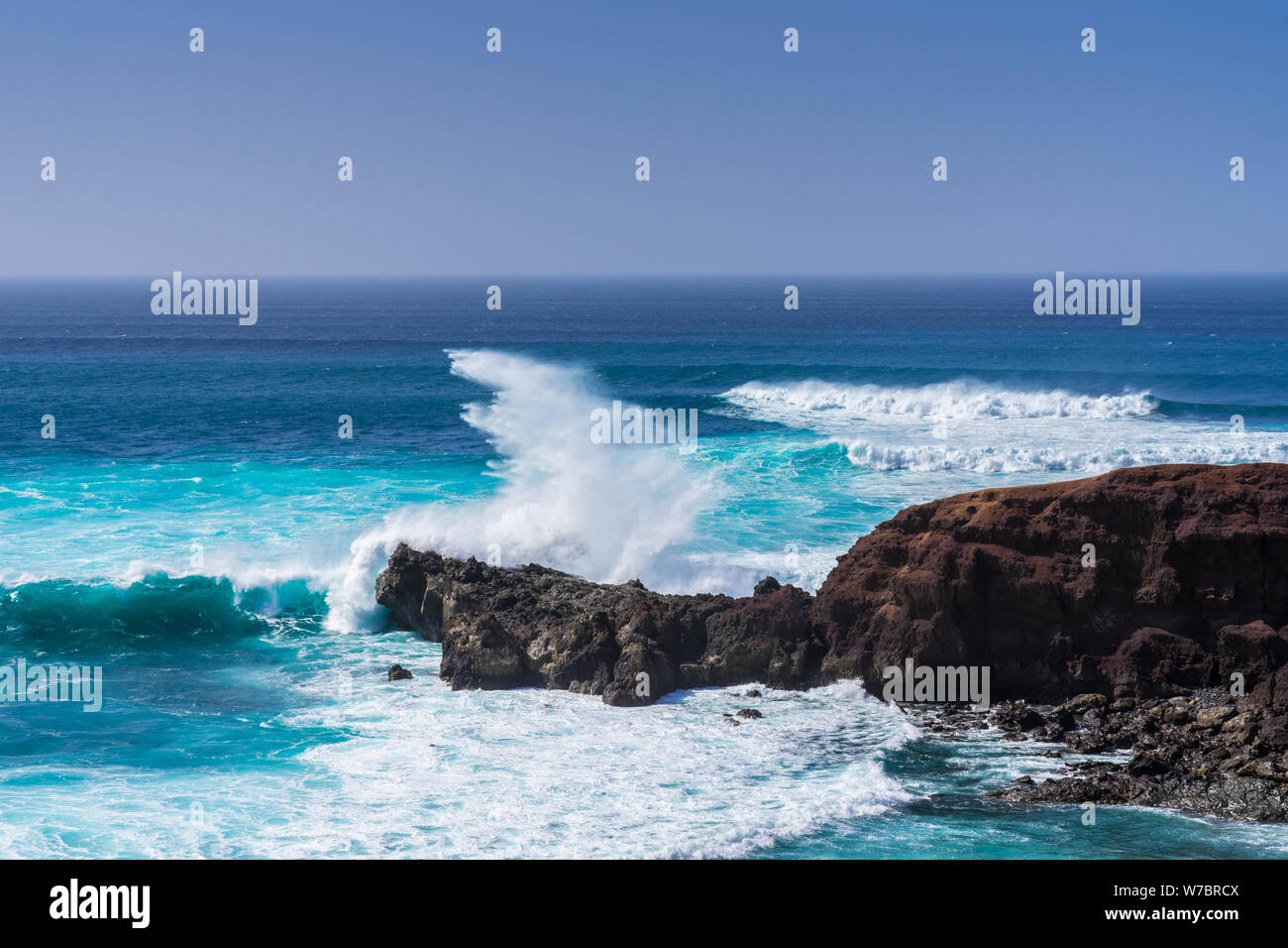 Spain, Lanzarote, Giant white spindrift of splashing ocean water at ...