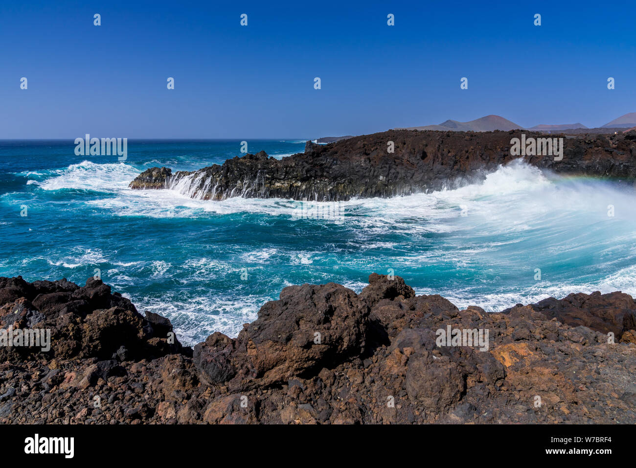 Spain, Lanzarote, Impressive big rogue wave forcing into little bay of ...