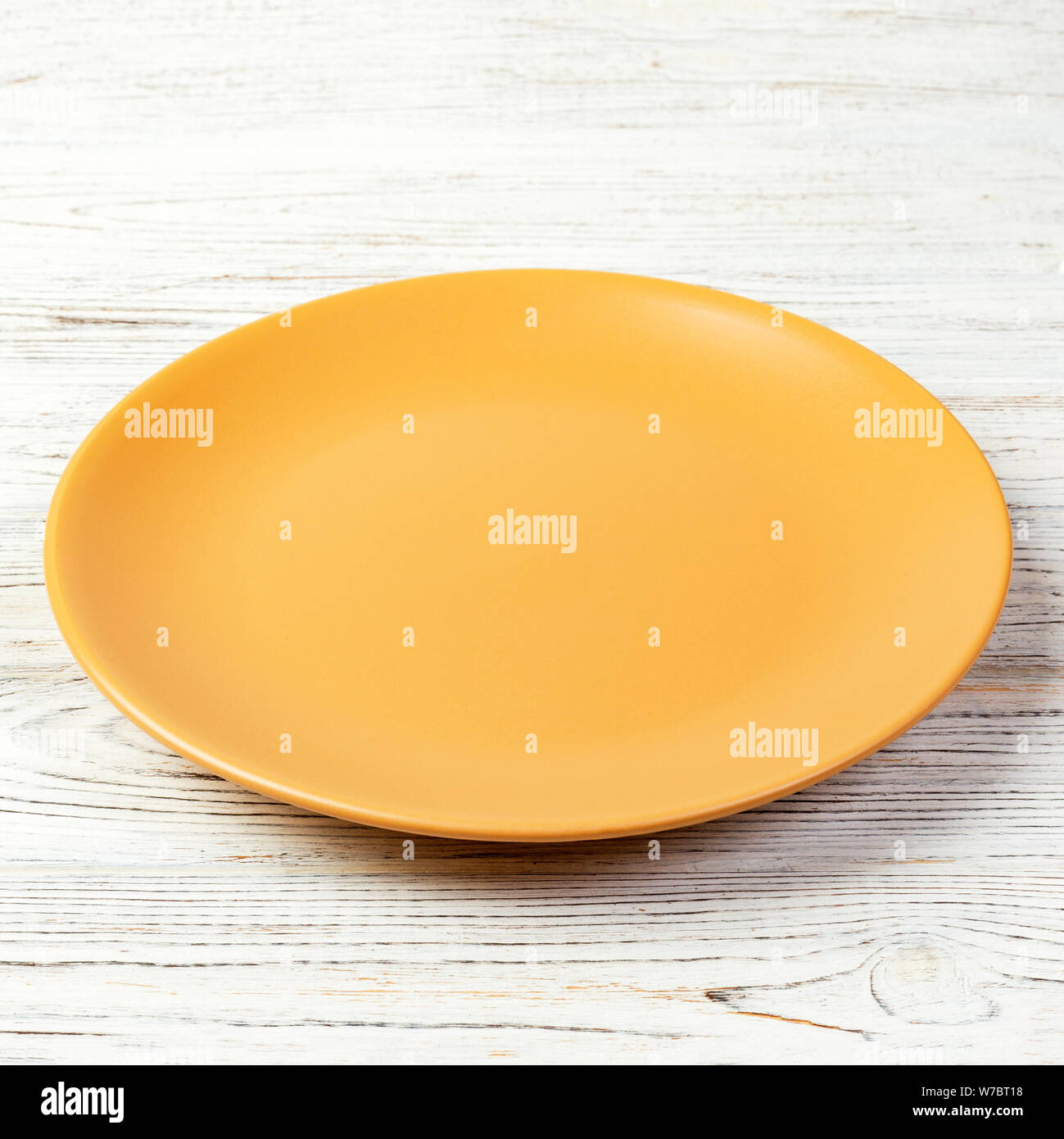 Yellow Round Plate on wooden table background. Top view, template for ...
