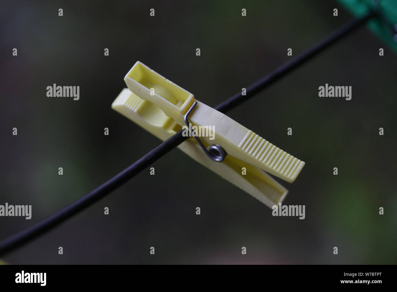 Plastic clothes pegs on a wire Stock Photo - Alamy