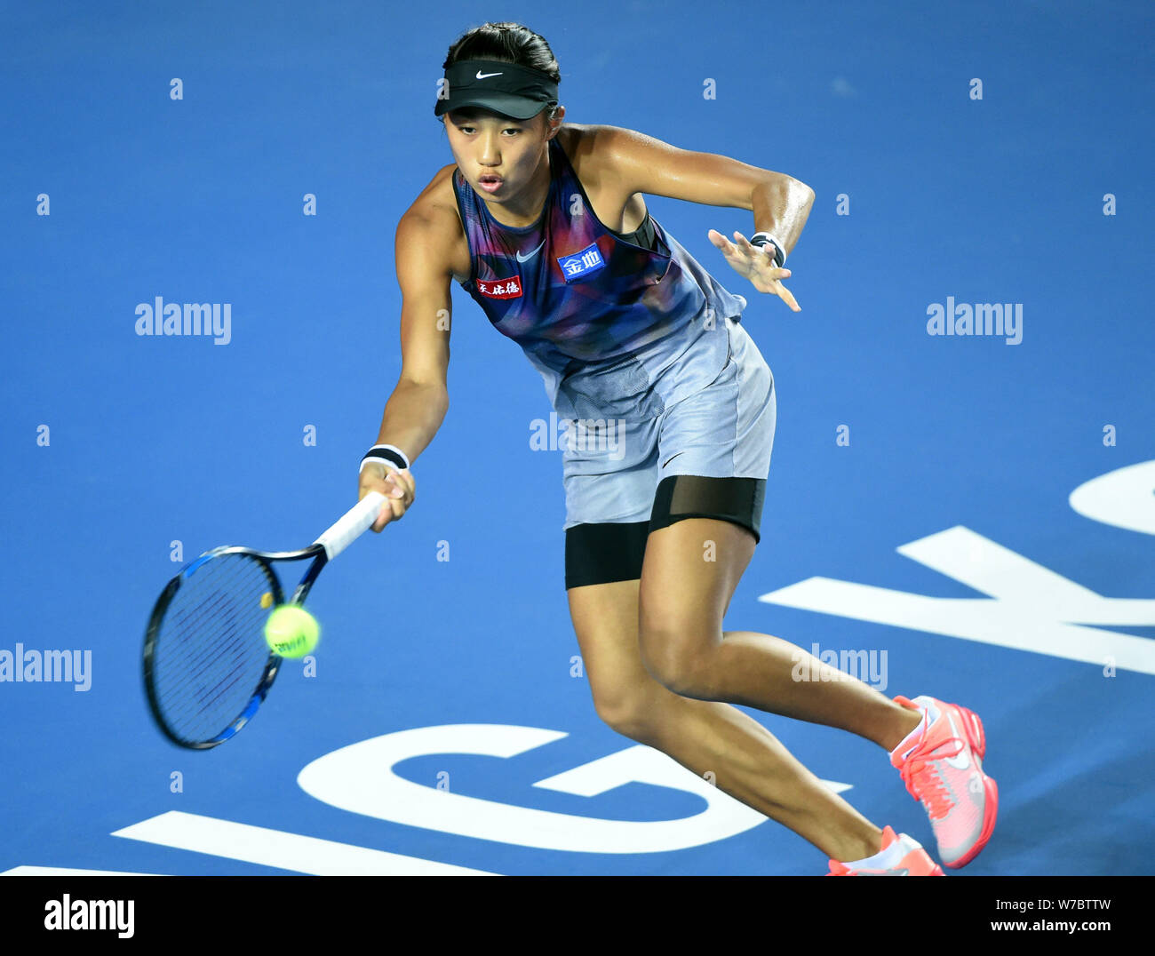 Zhang Shuai of China returns a shot to Kurumi Nara of Japan in their ...